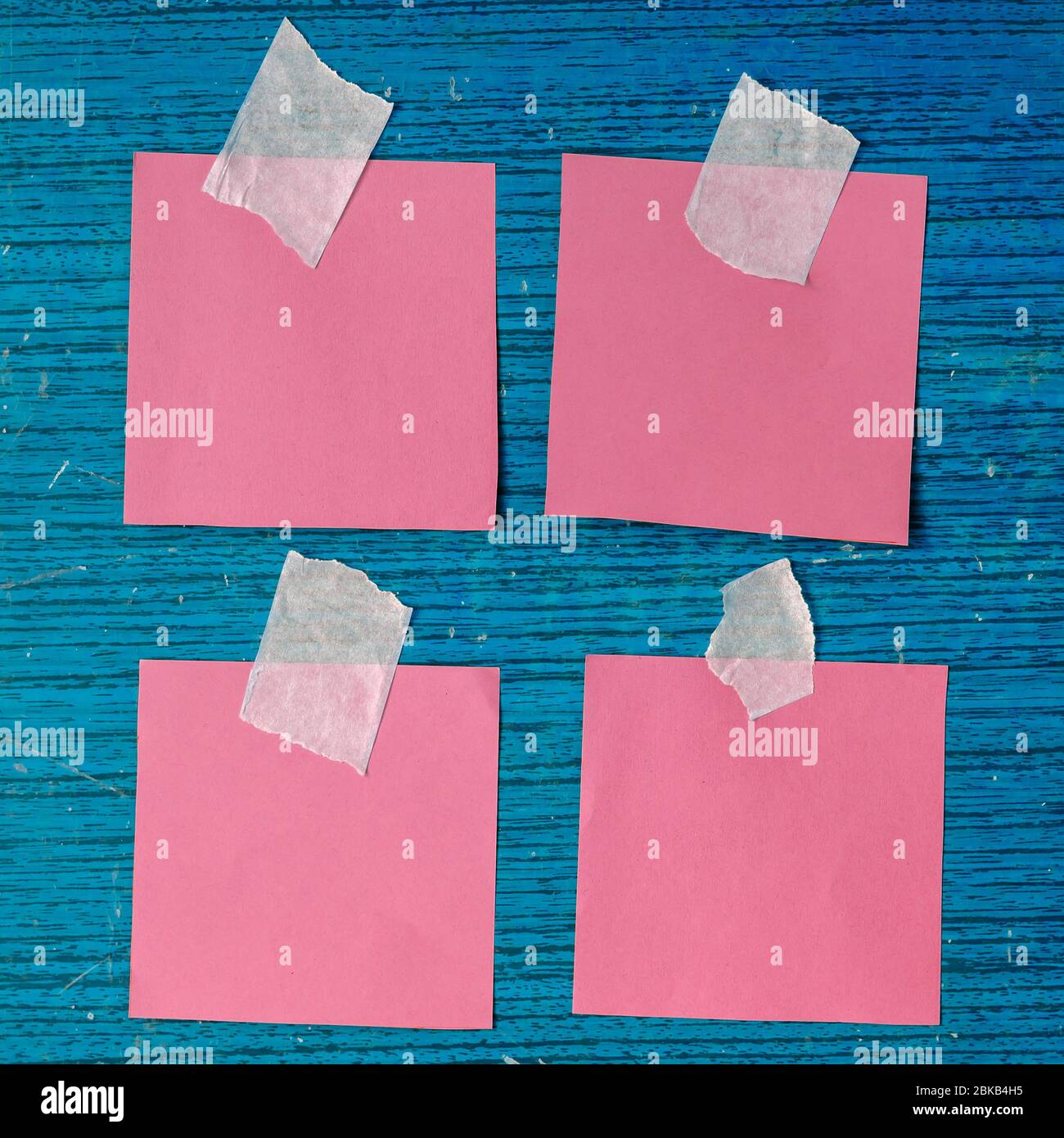 Creative blue background with colored paper. Four pieces of pink paper ...