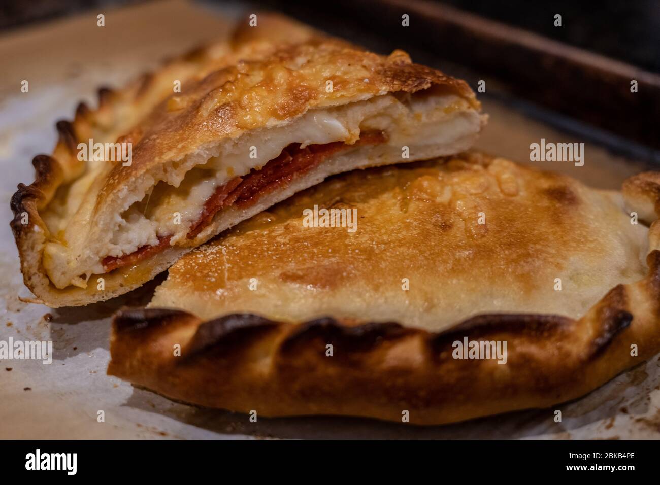 Cross Section of Homemade Calzone on parchment paper Stock Photo - Alamy