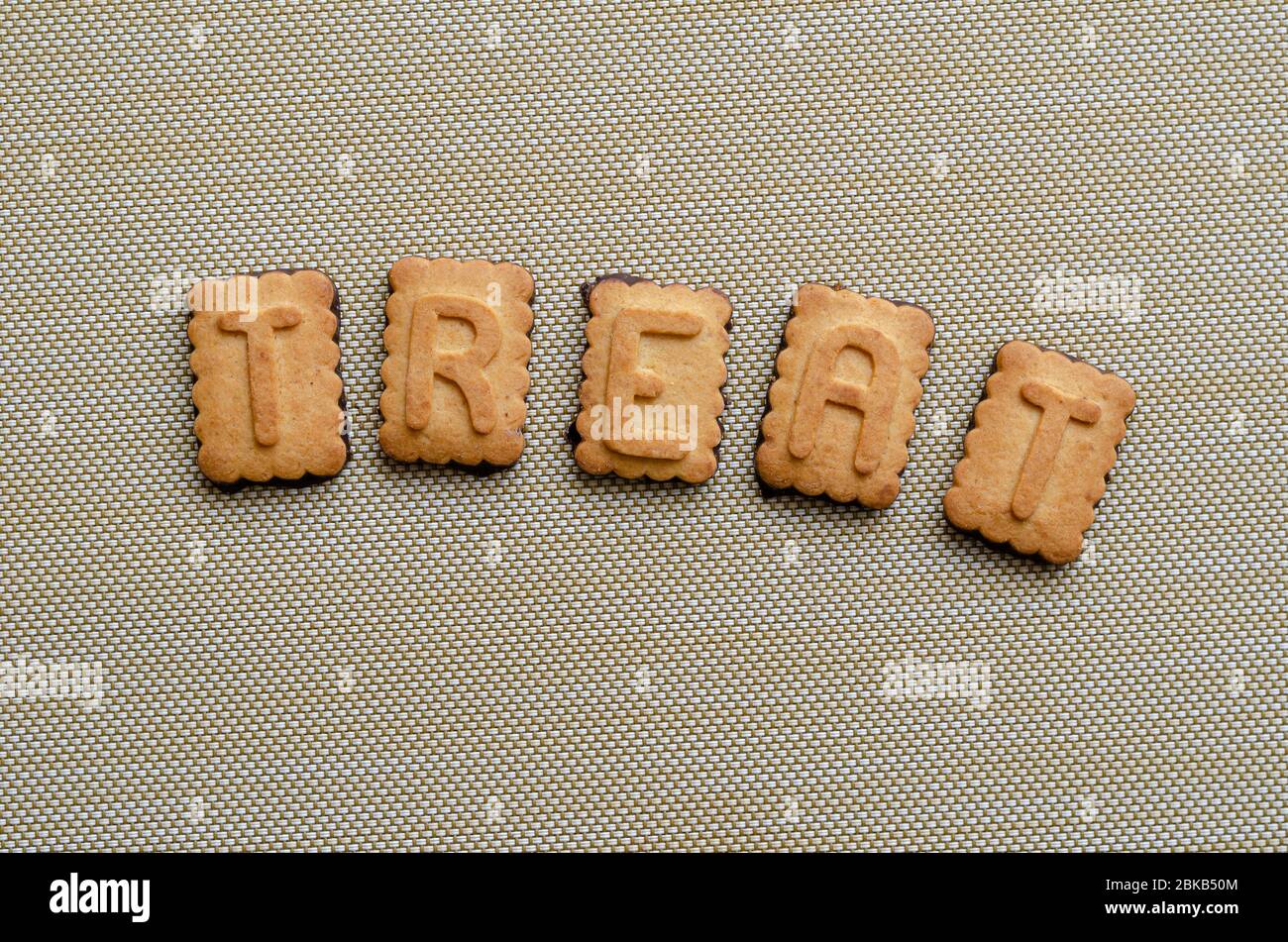 The word TREAT is a cookie alphabet. Single word on a beige background ...