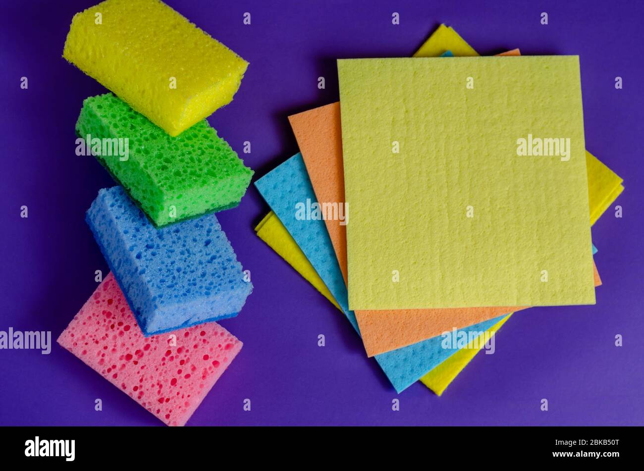 Kitchen napkins and sponges on a blue background. Set of multi-colored ...