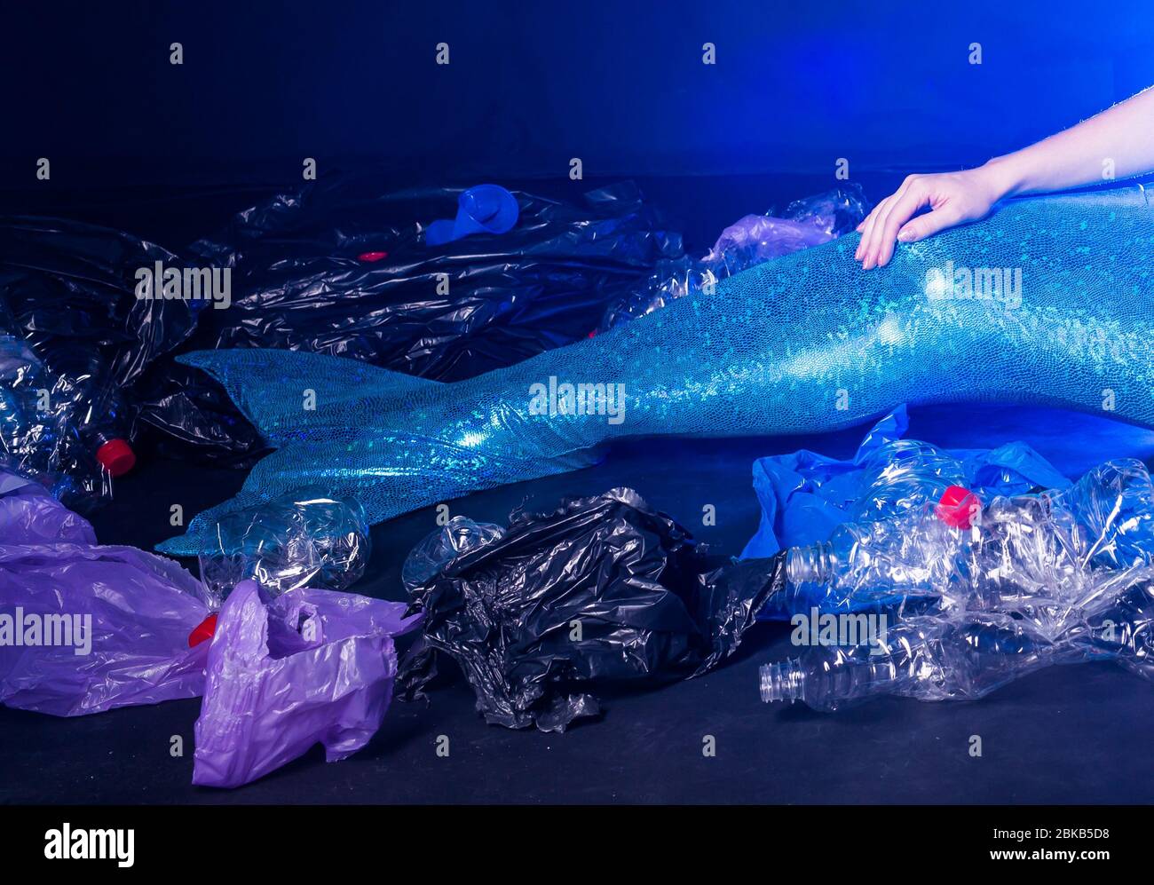 Ocean pollution, rubbish in the water. Close-up fairytale mermaid in ...