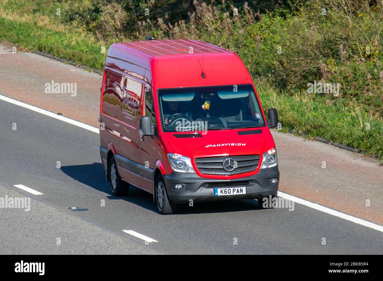 2015, Panavision red Mercedes Benz panel van; Vehicular traffic moving ...