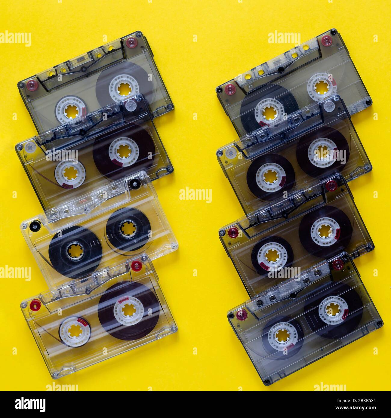 Collection of old audio tapes on a yellow background. Collection of ...