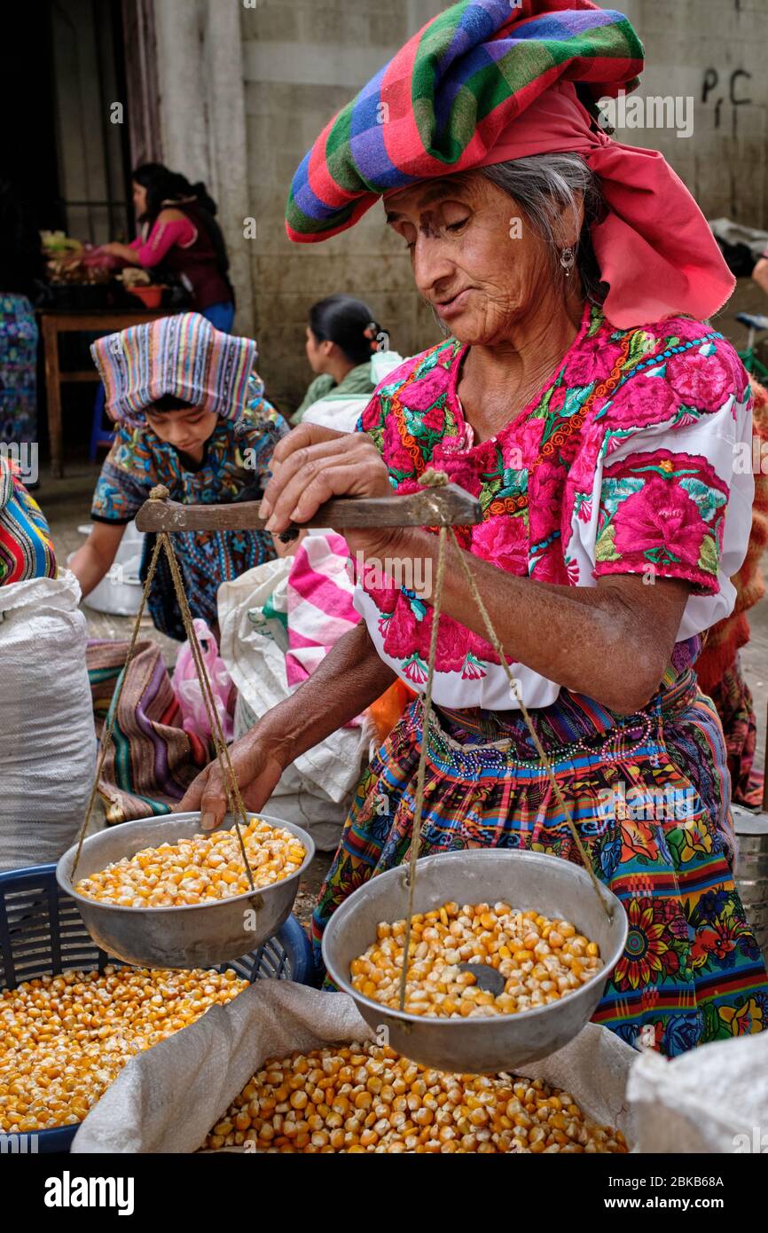 Woman dressed with indigenous colourful outfit selling corn in a local ...