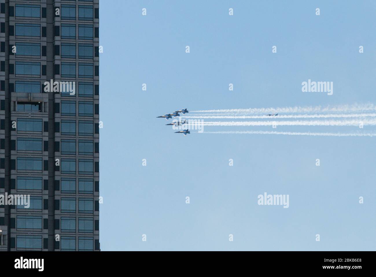 The Navy Blue Angels fly behind a building as they join the Air Force ...