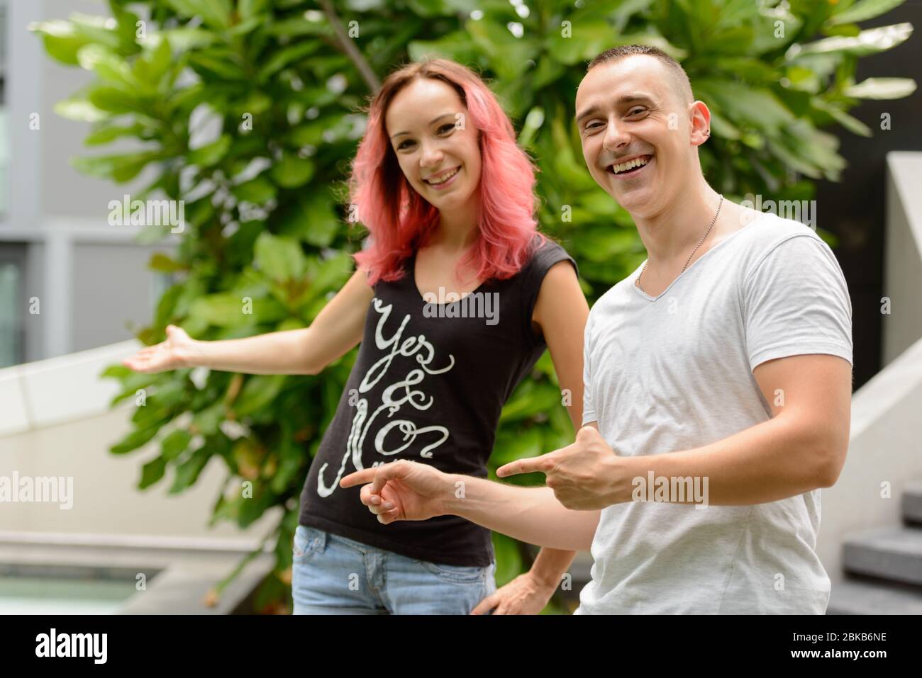 Portrait of happy couple showing something together in the swimming ...