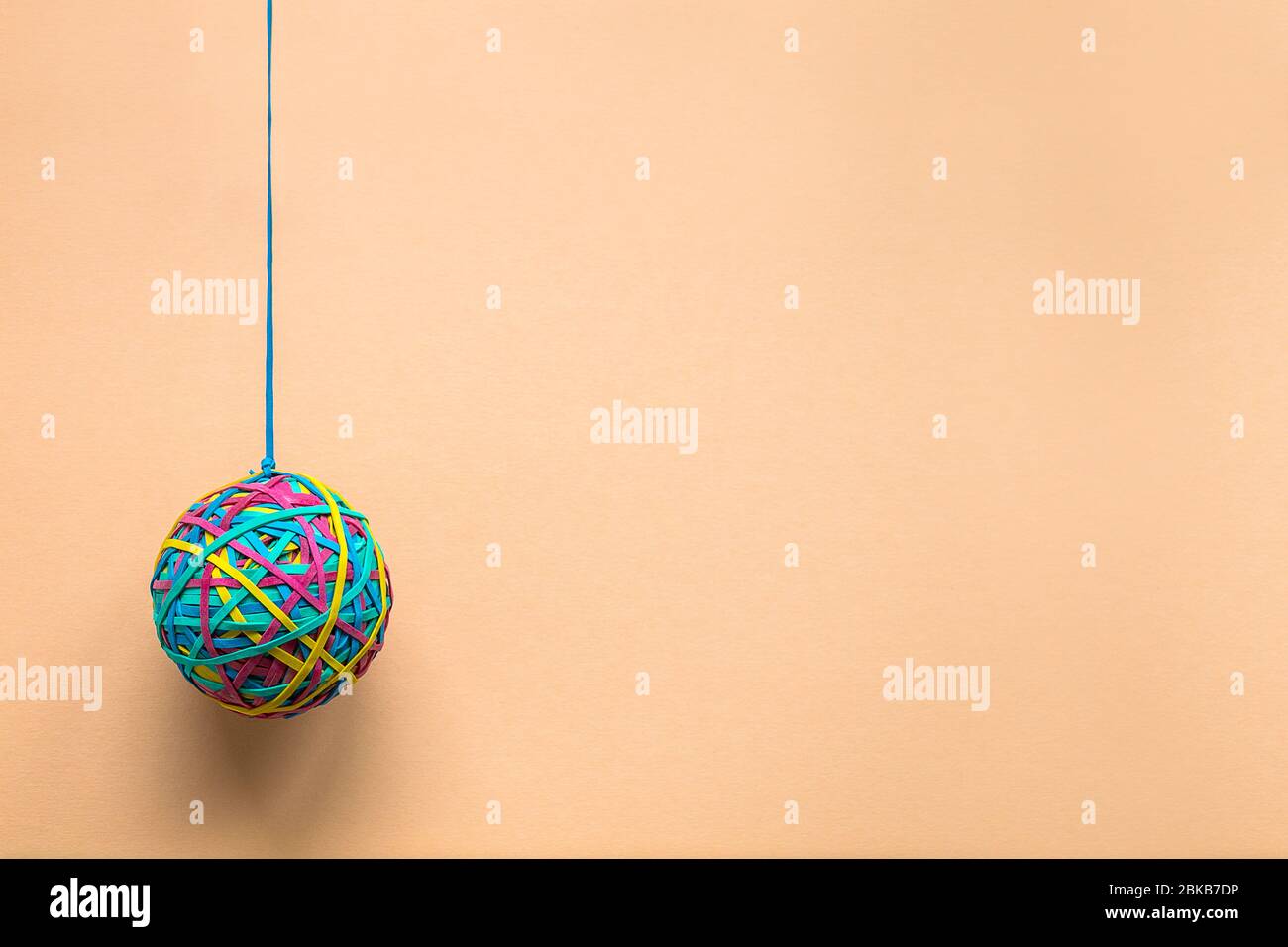 Rubber band ball on colored paper Stock Photo - Alamy