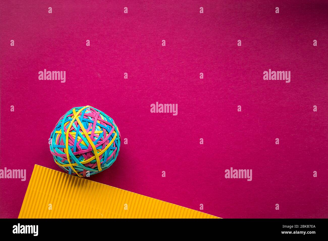 Rubber band ball on colored paper Stock Photo - Alamy