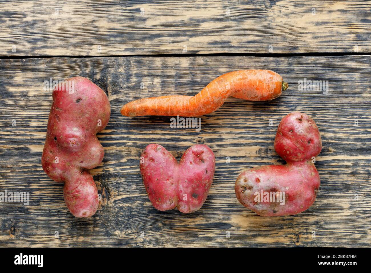 Ugly funny vegetables, heart-shaped potatoes and twisted carrot on a ...