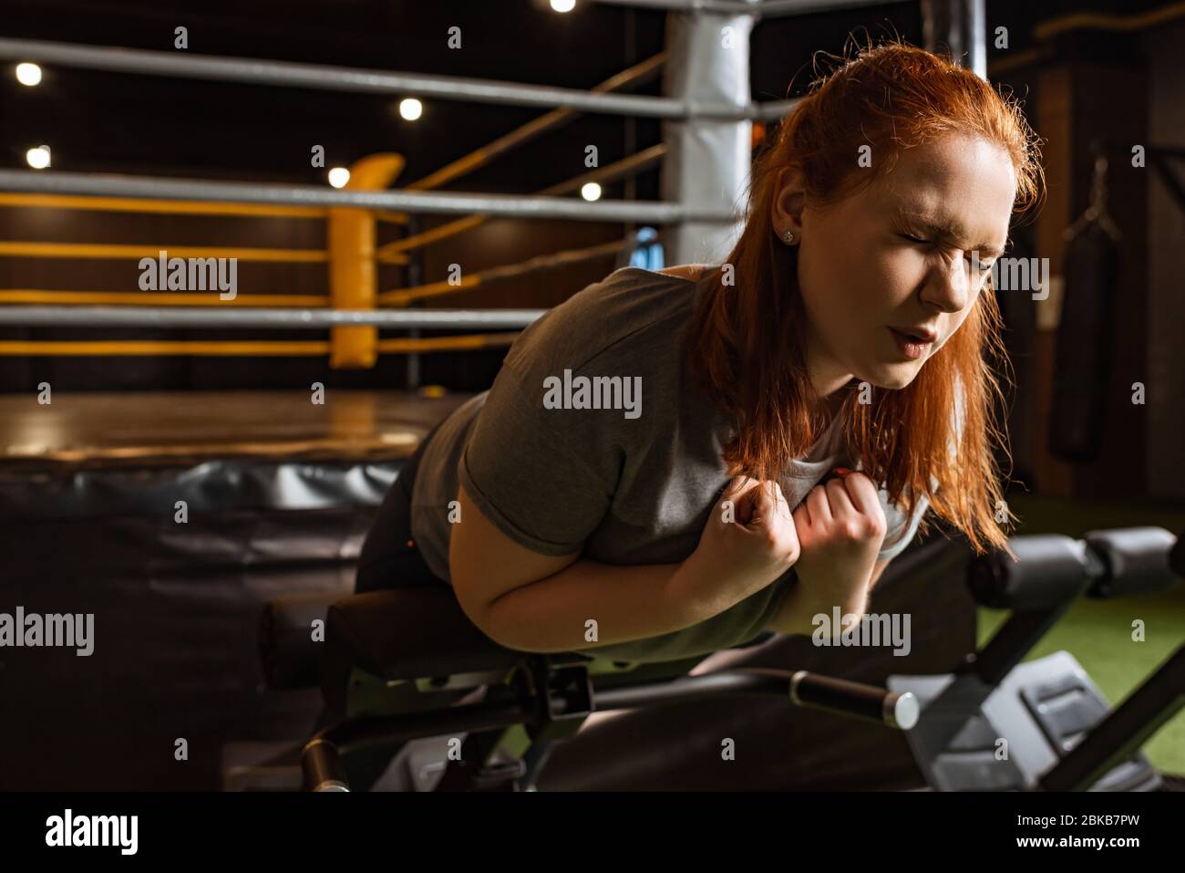 overweight girl with closed eyes doing lower back extension exercise on ...