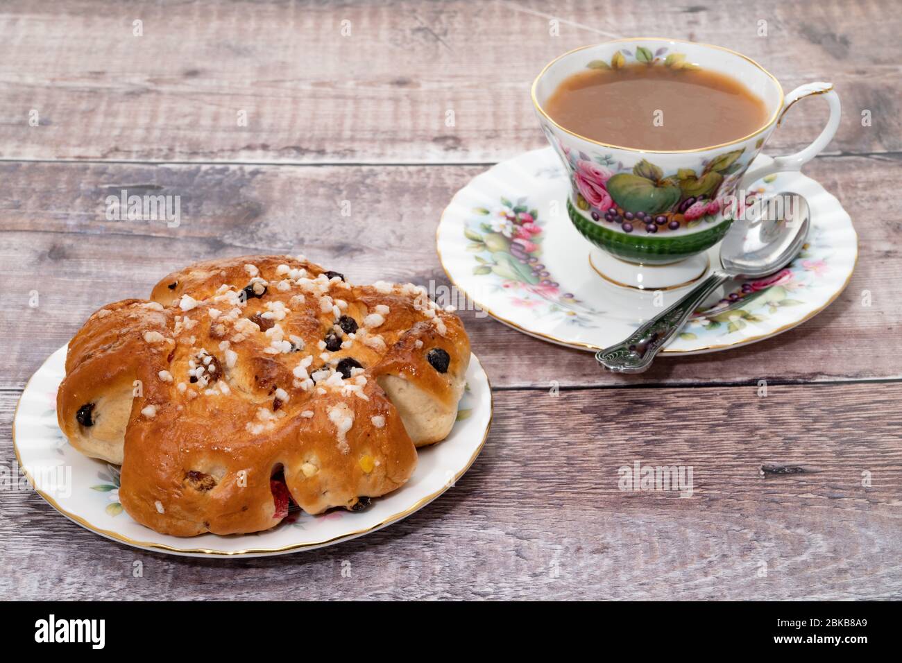 Classic British bath bun with a cup of tea Stock Photo - Alamy