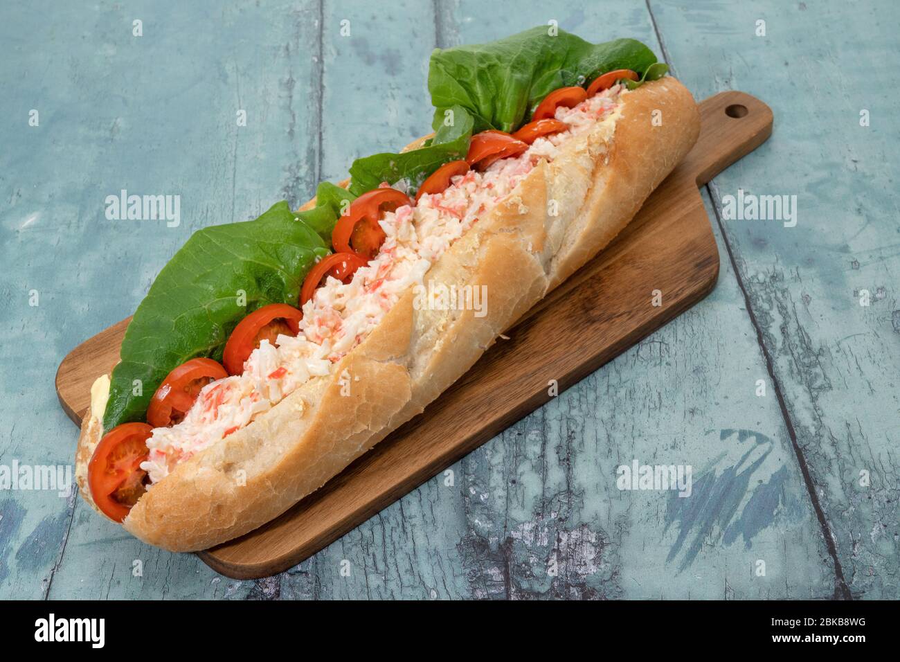 Crab salad sub sandwich - wood background Stock Photo - Alamy