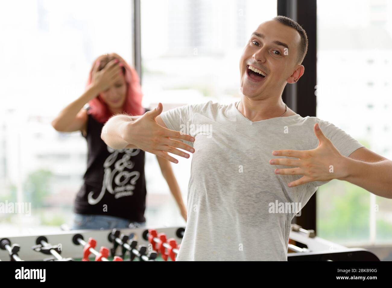 Portrait couple playing foosball hi-res stock photography and images ...
