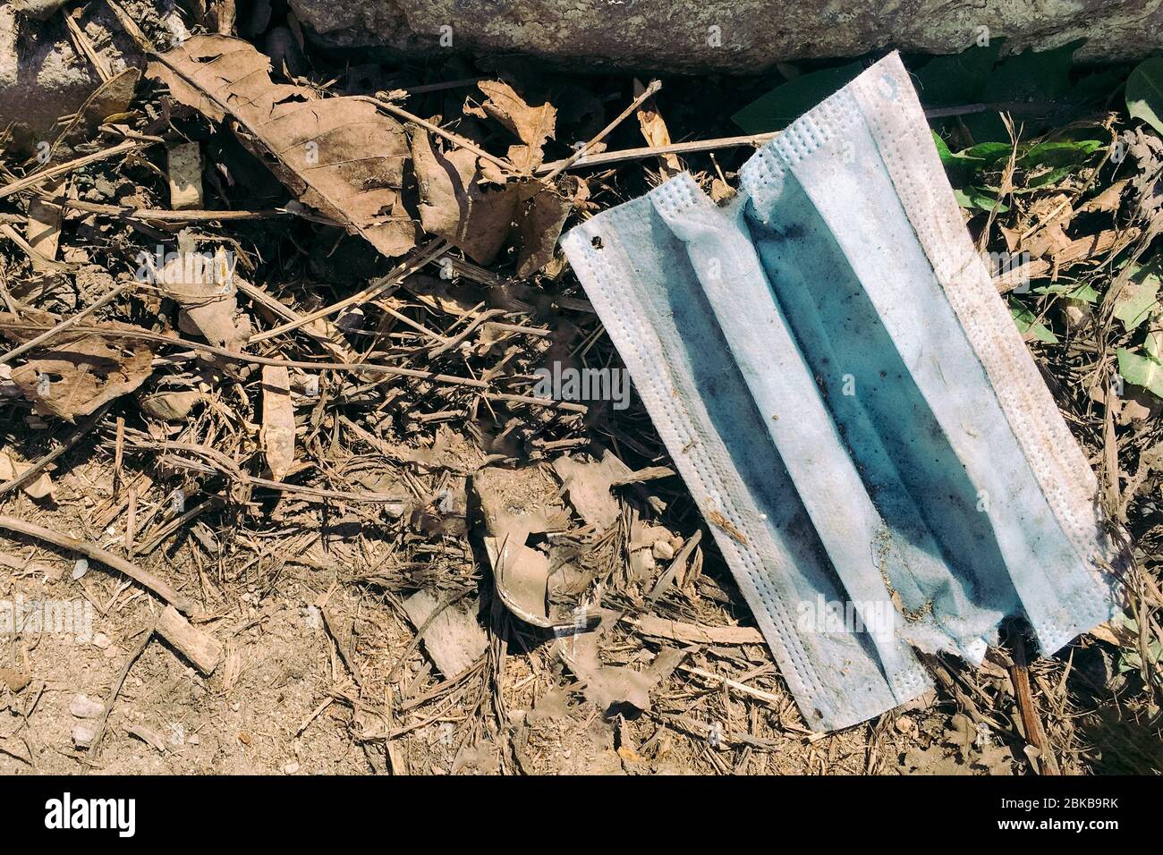 A used medical face mask dumped on the ground during the Covid-19 ...