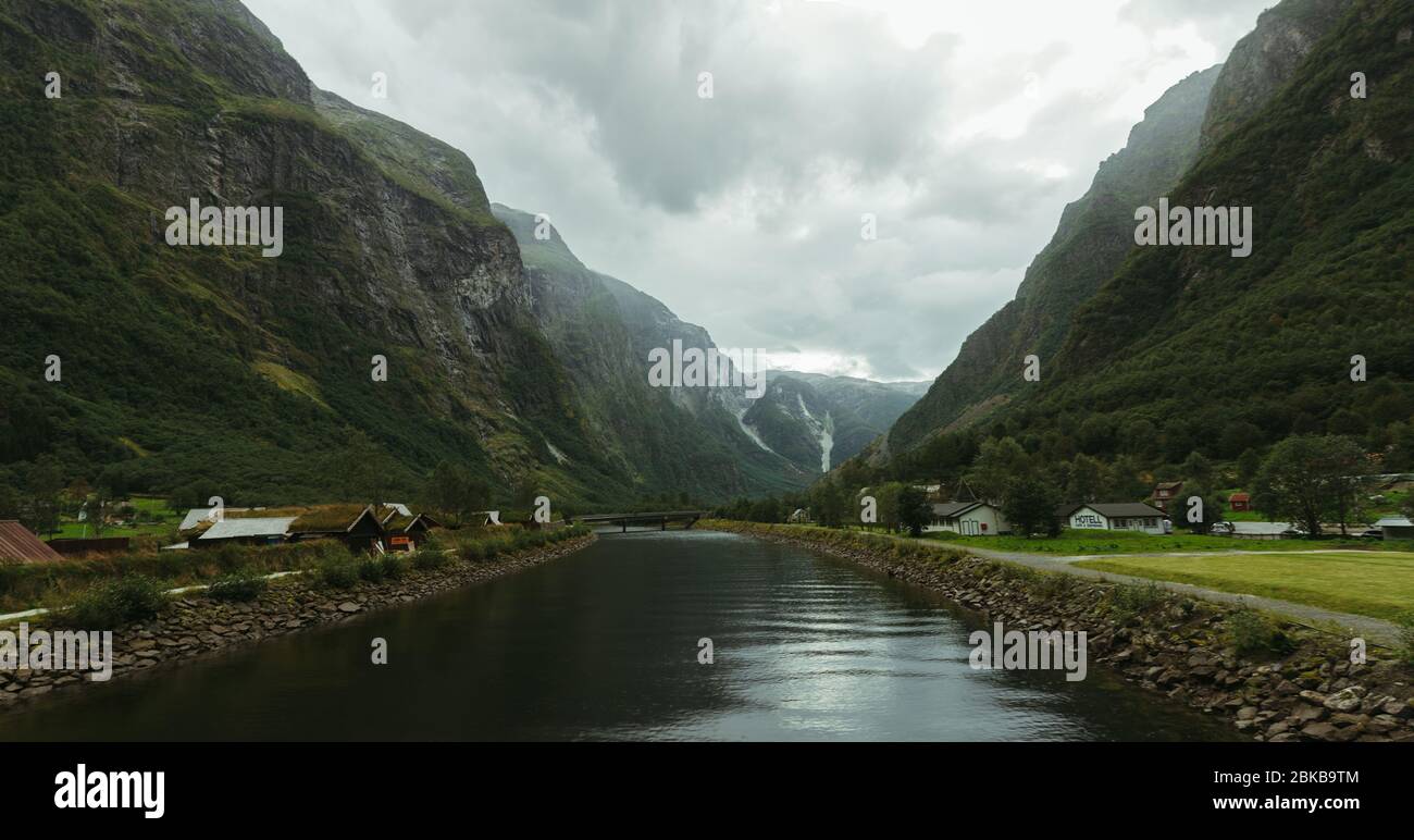 a small river between two mountains in norway at the bottom of the ...
