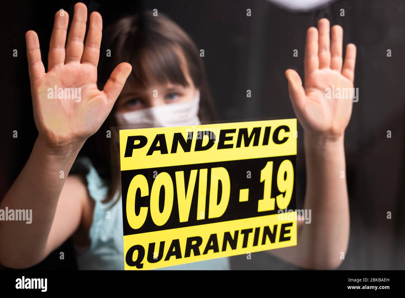 Stay at home. Sad lonely child in medical mask isolation in quarantine ...