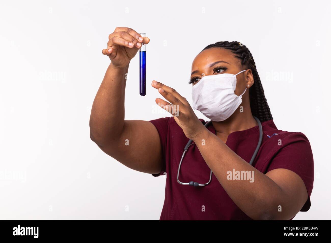 Glass tube with blue fluid in nurse hand during medical test. Vaccine ...