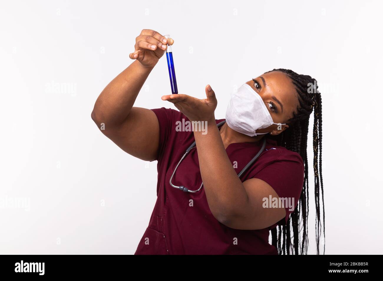 Glass tube with blue fluid in nurse hand during medical test. Vaccine ...
