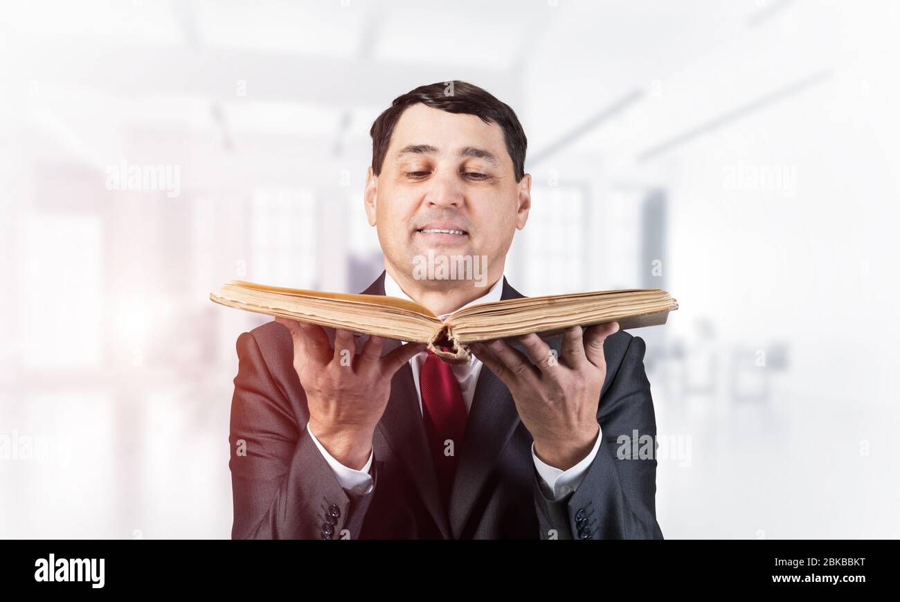 Senior businessman looking in open book Stock Photo - Alamy