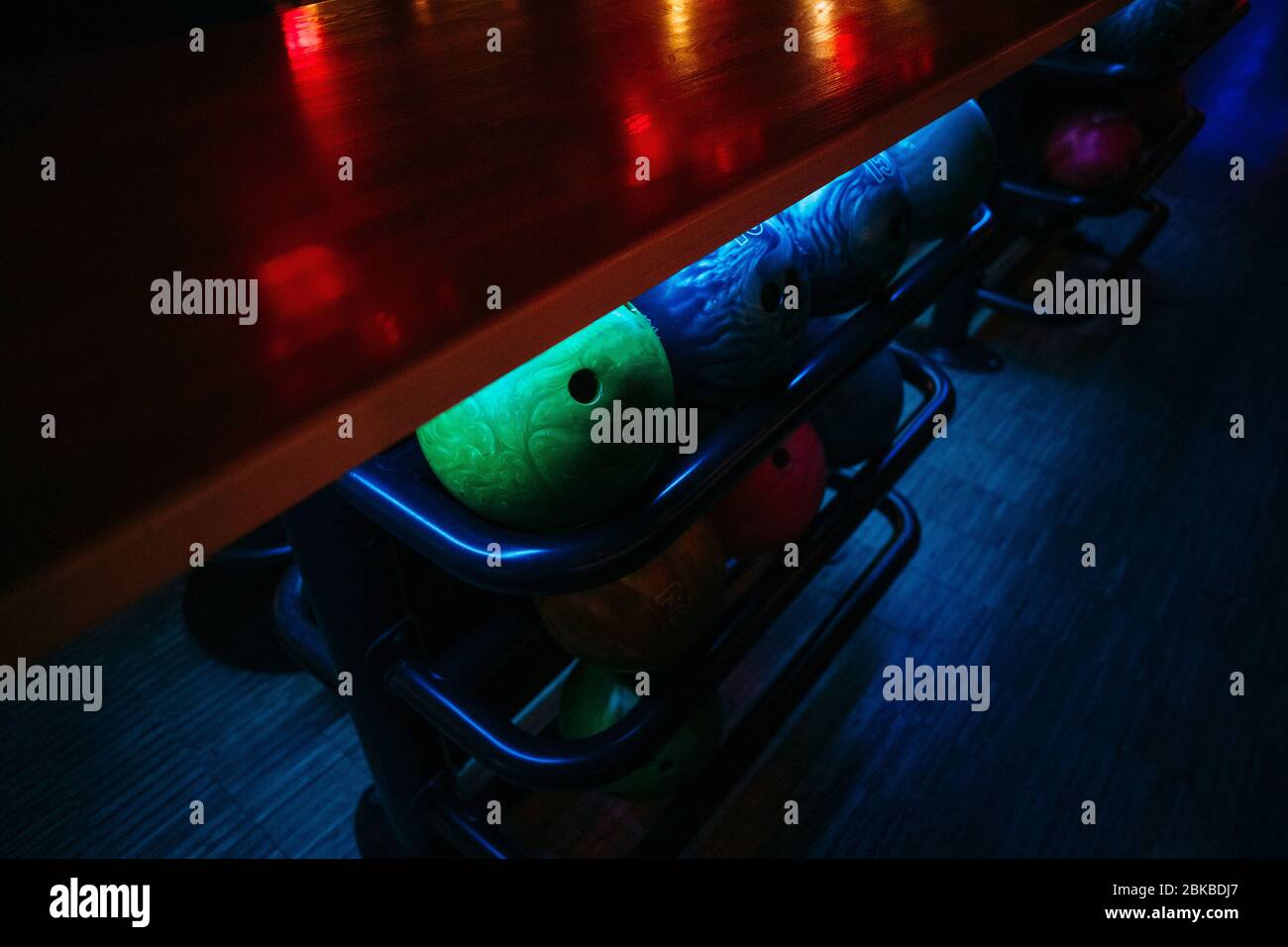bowling balls under the table on which the light falls, background ...