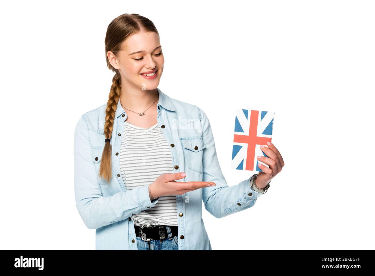 smiling pretty girl with braid presenting book with uk flag isolated on ...