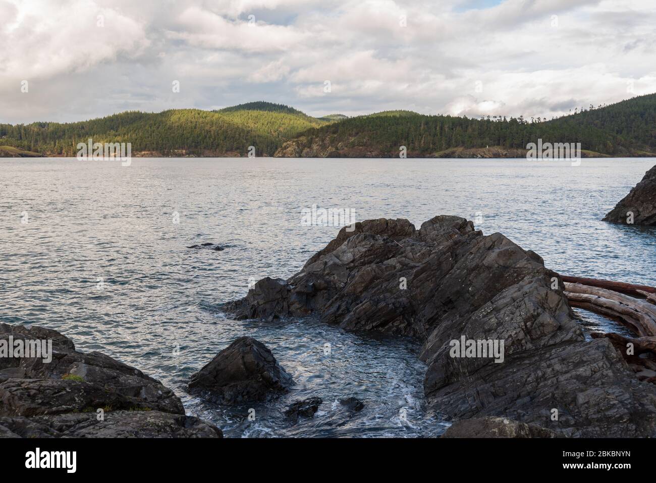 Landscape of rocks, ocean and distant hills at Deception Pass State ...
