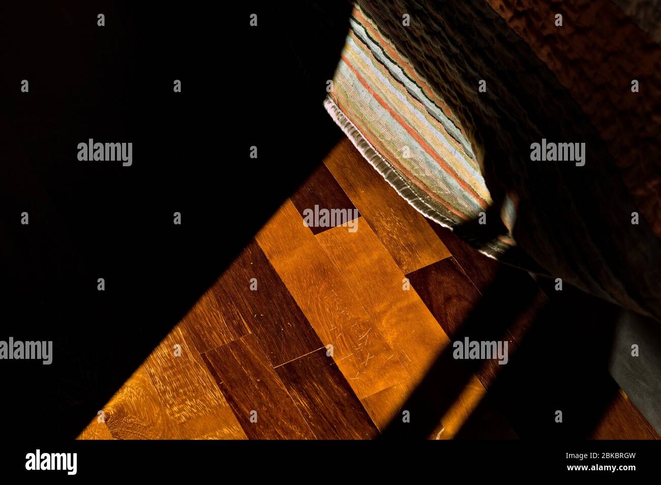 The light that filters through the window illuminates the parquet and a ...