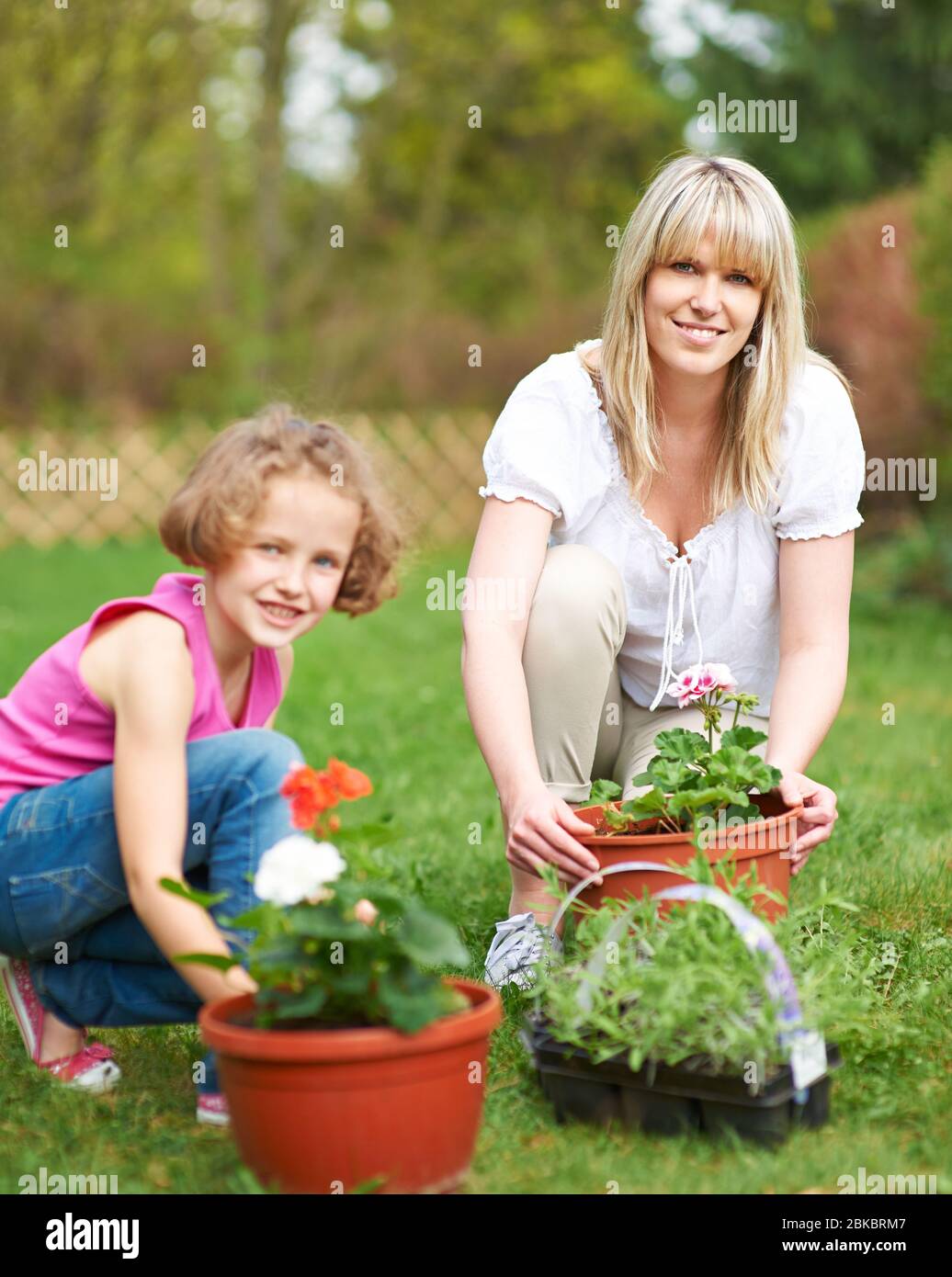 Mother and daughter gardening together in summer Stock Photo - Alamy