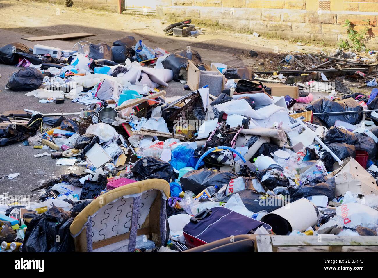 Fly tipping of waste and rubbish black bin bags in residential area ...