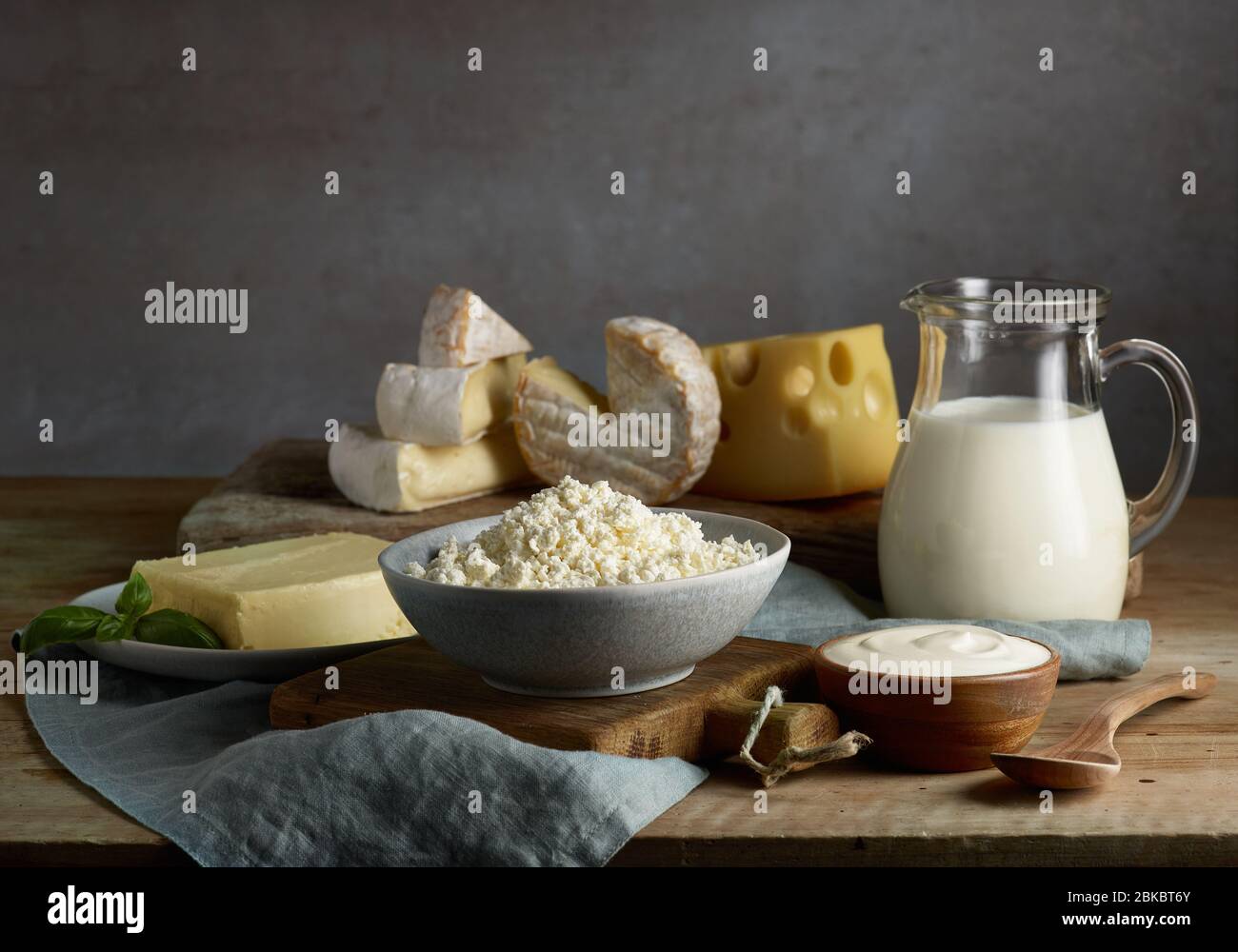 milk and various dairy products on old wooden kitchen table Stock Photo ...