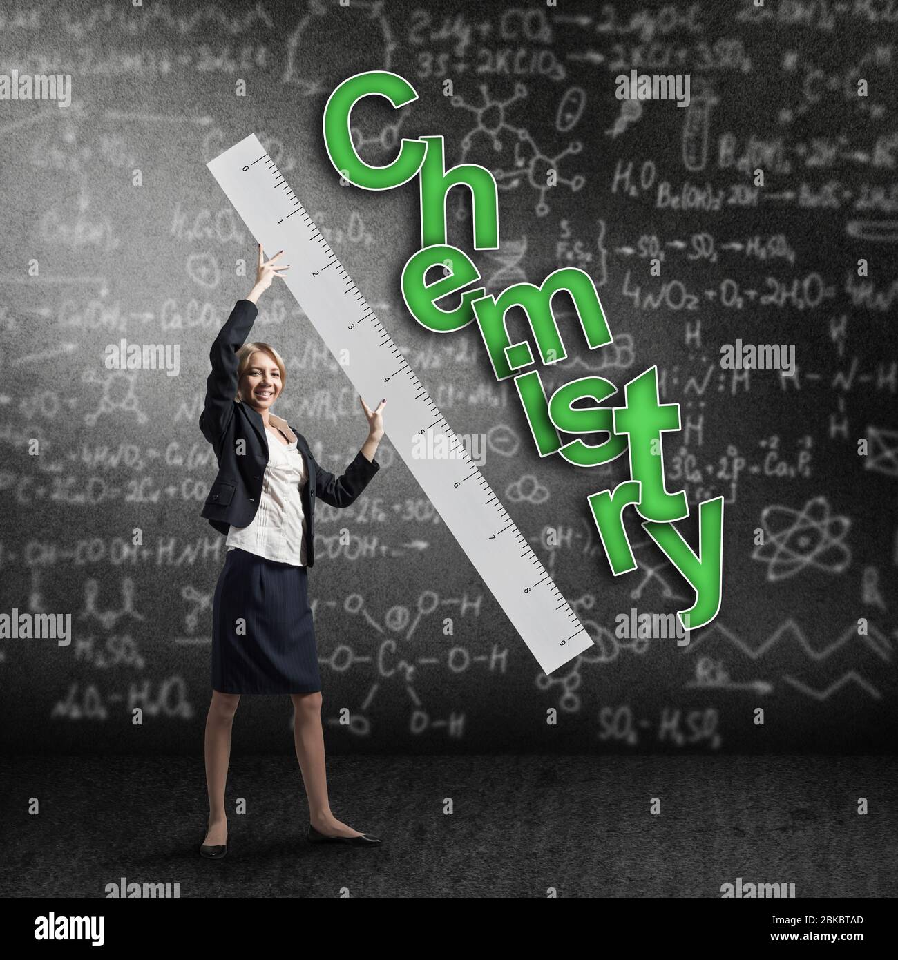 Young chemistry teacher holding big ruler Stock Photo - Alamy