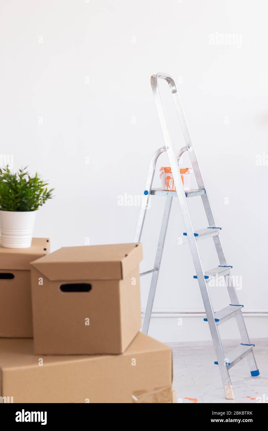 Ladder with paint in bucket near color wall indoors. Renovation and ...