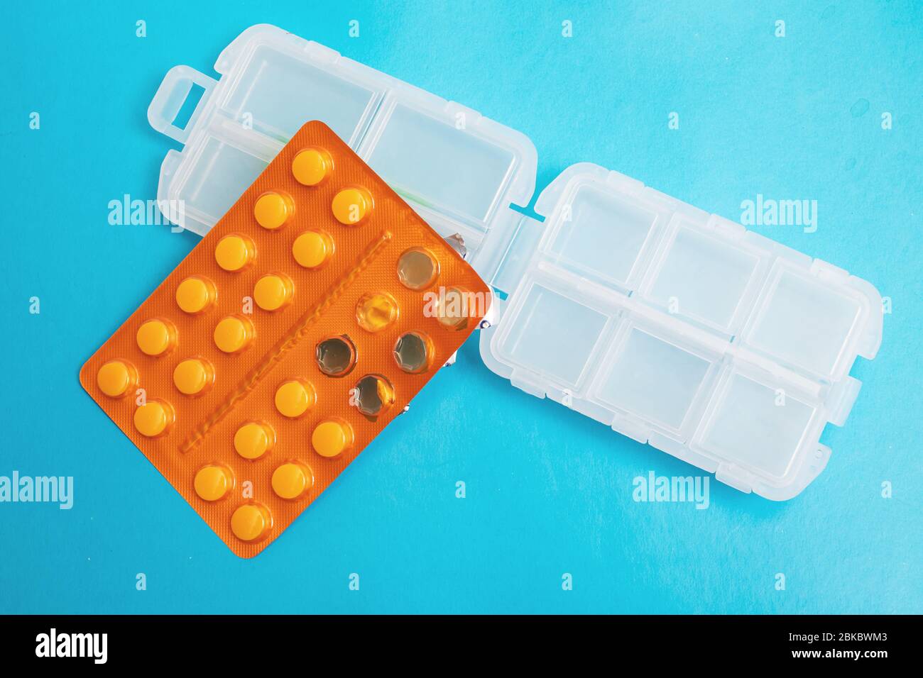 Plastic container for pills and pills pack on blue background Stock ...