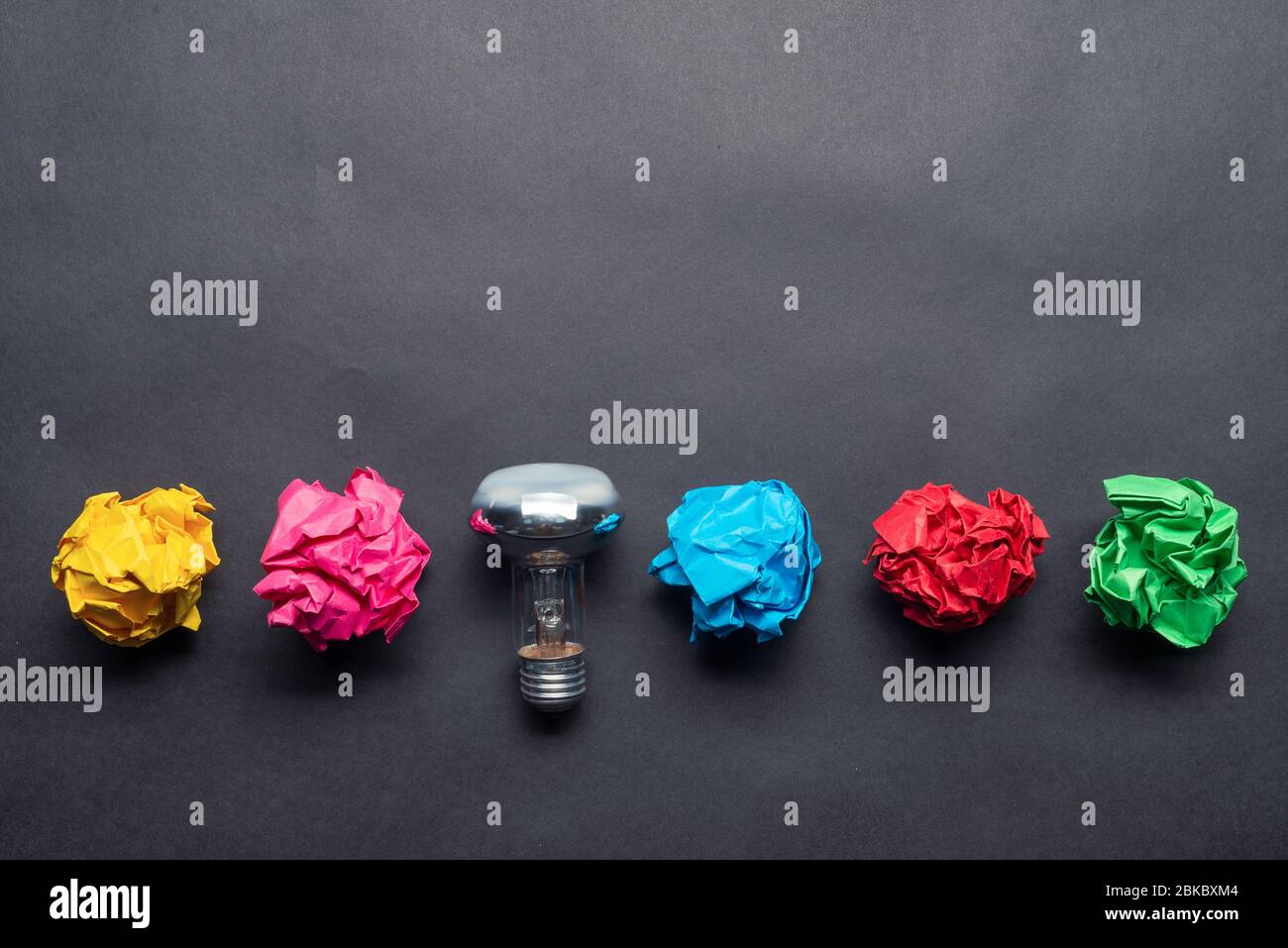 Lightbulb and crumpled colorful paper balls Stock Photo - Alamy