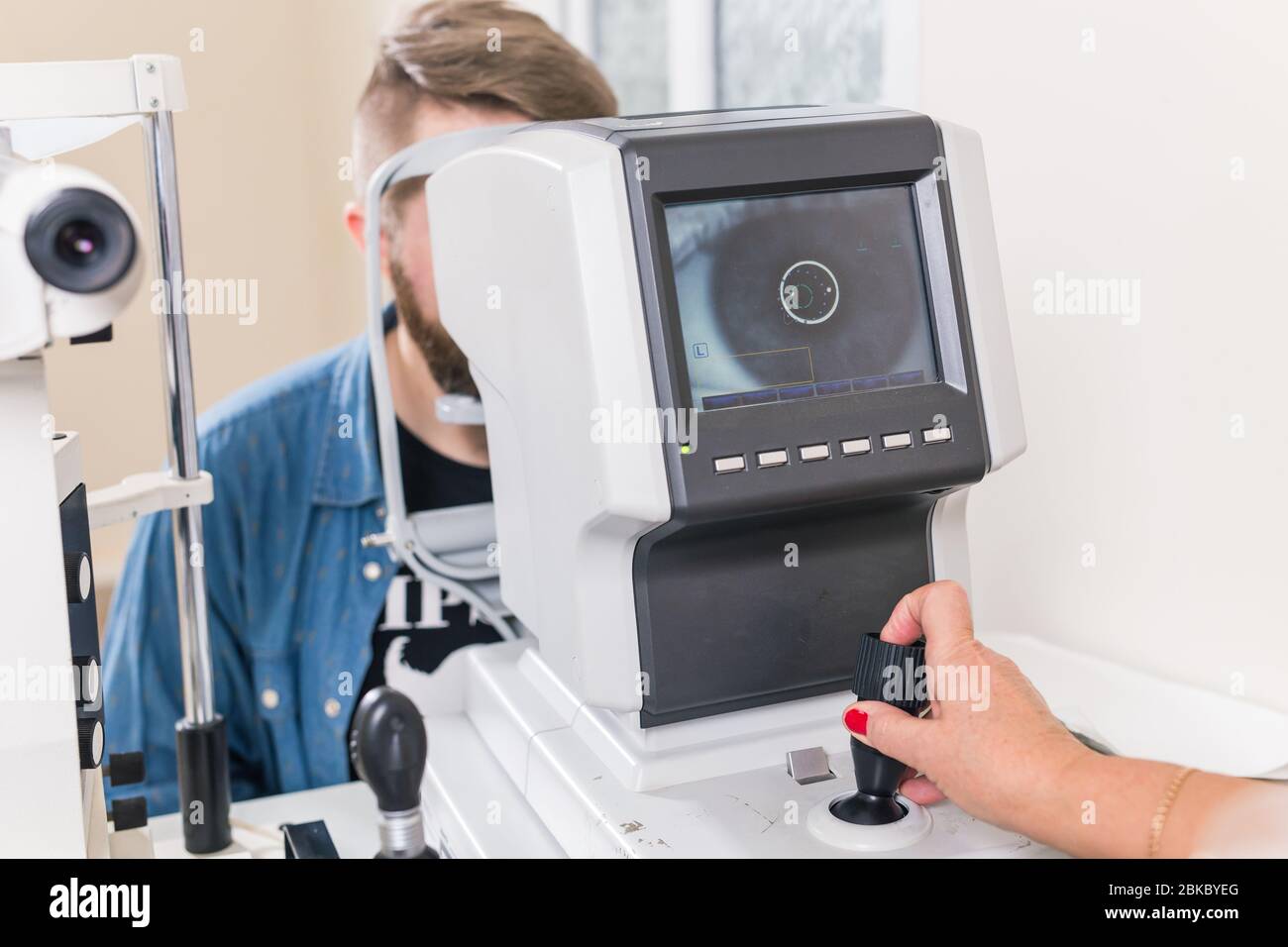 Medicine, health, ophthalmology concept - patient checks her vision by ...