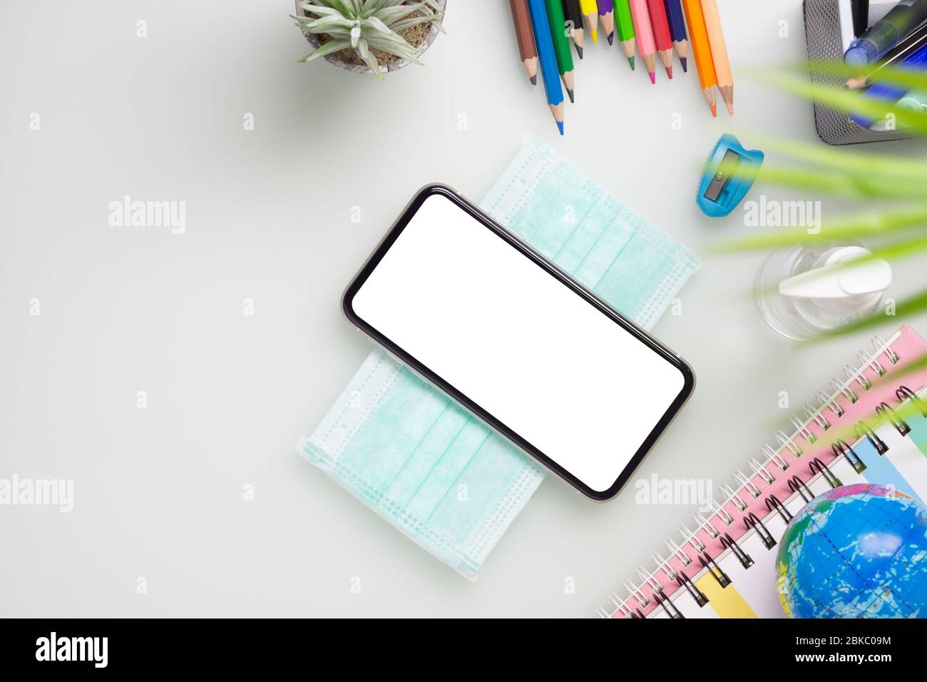 Mockup mobile phone with student's stationary for Home schooling ...