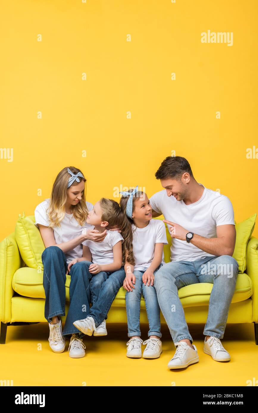 happy parents talking with adorable daughter and son while sitting ...
