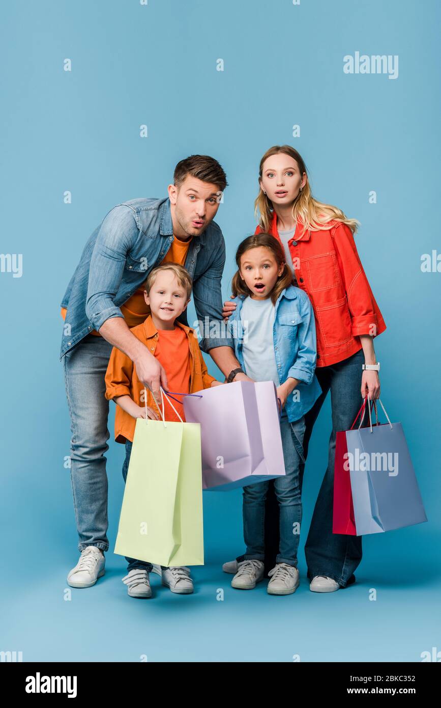 Parents children holding shopping bags hi-res stock photography and ...