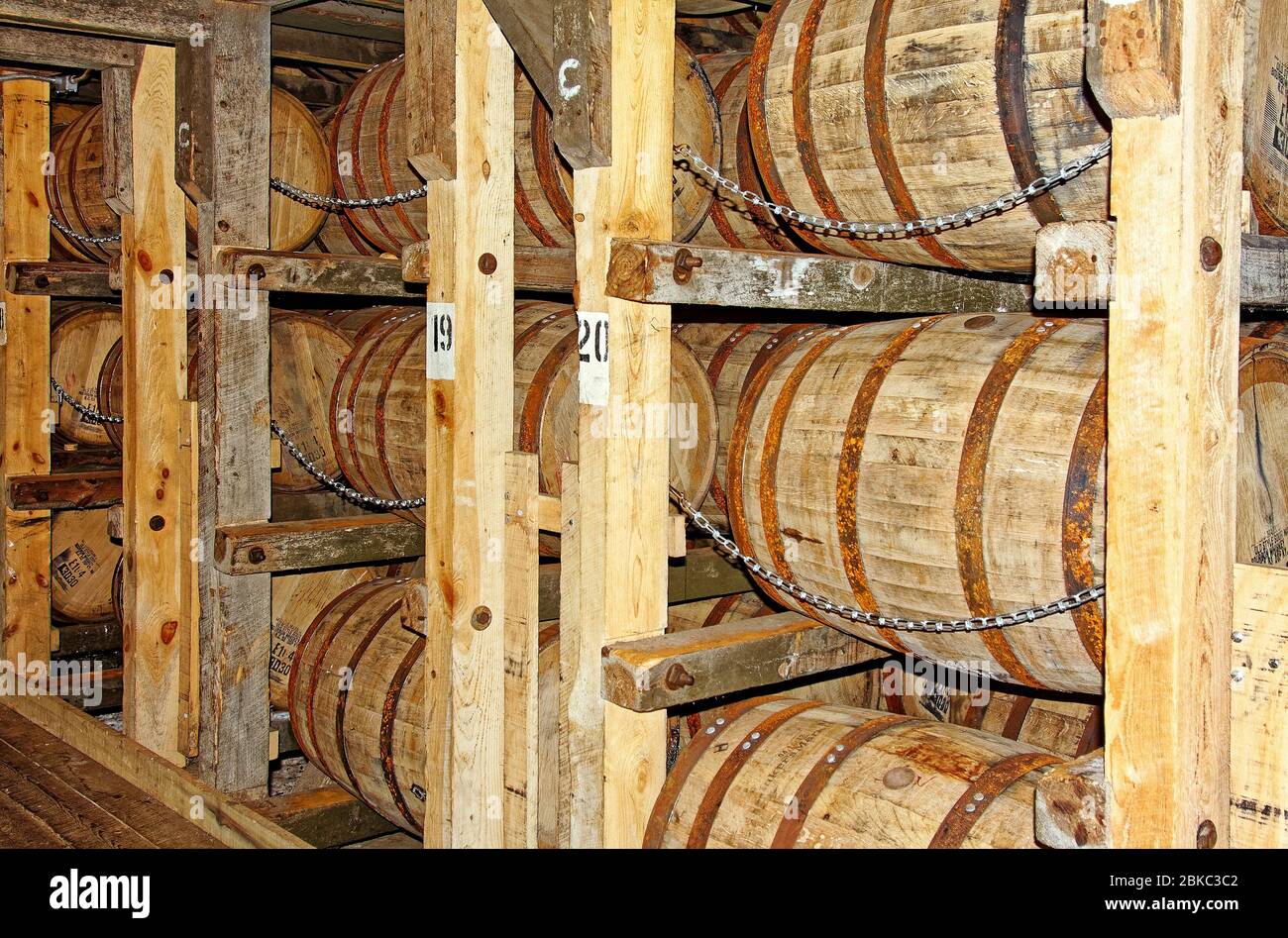 barrels of bourbon, cypress planks, aging, rickhouse, stacks of 3 high ...