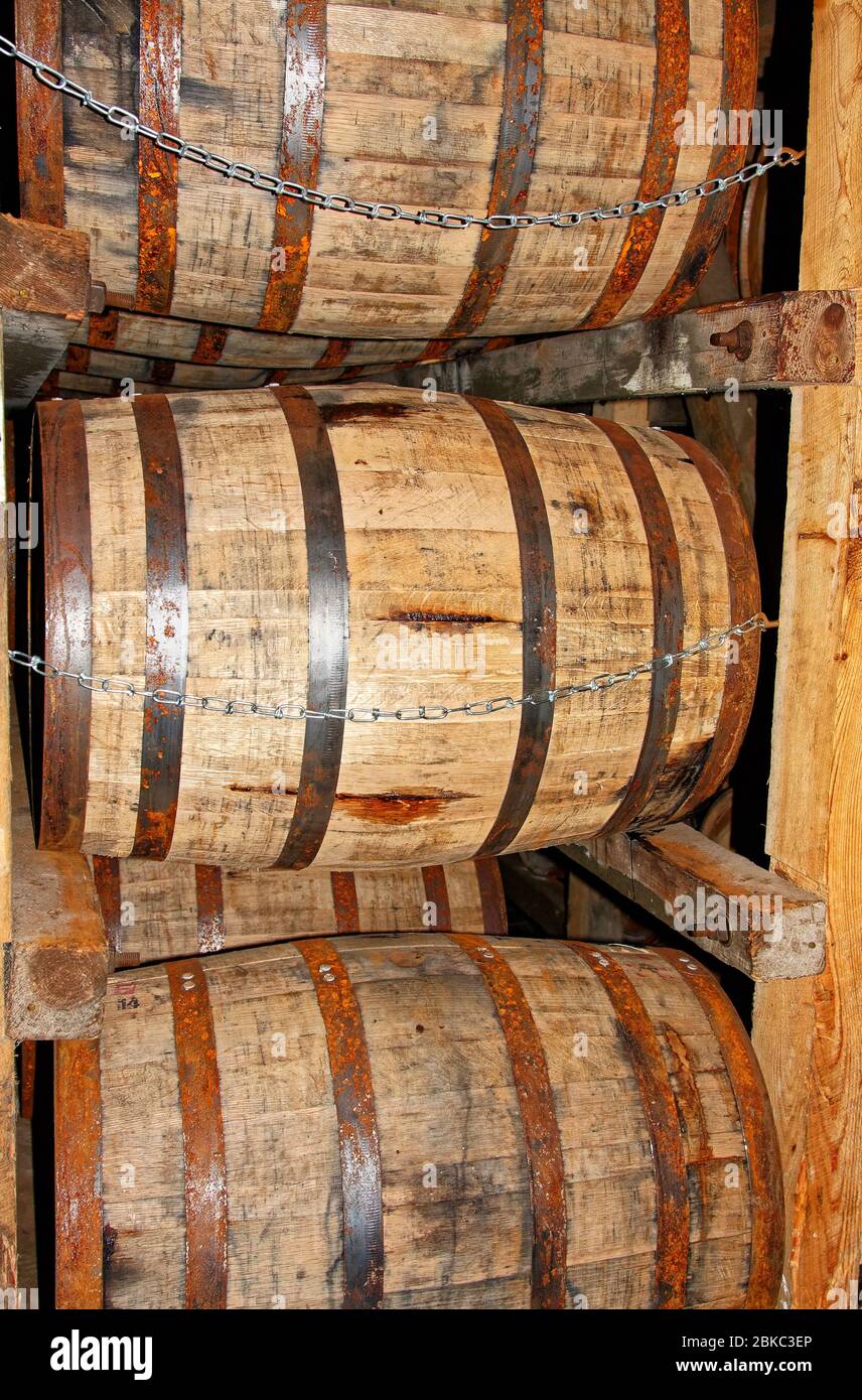barrels of bourbon, cypress planks, aging, rickhouse, stacks of 3 high ...