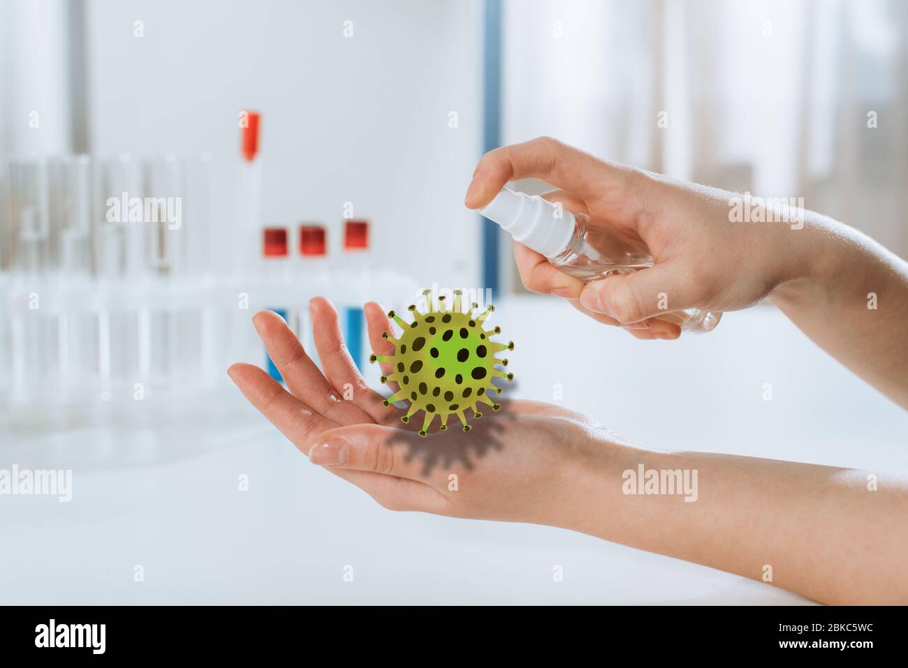 cropped view of doctor spraying antiseptic on hands near test tubes ...