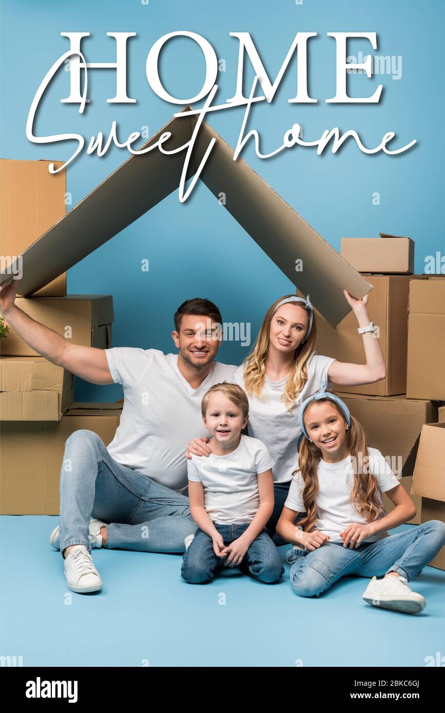 positive parents holding carton roof over kids on blue with cardboard ...