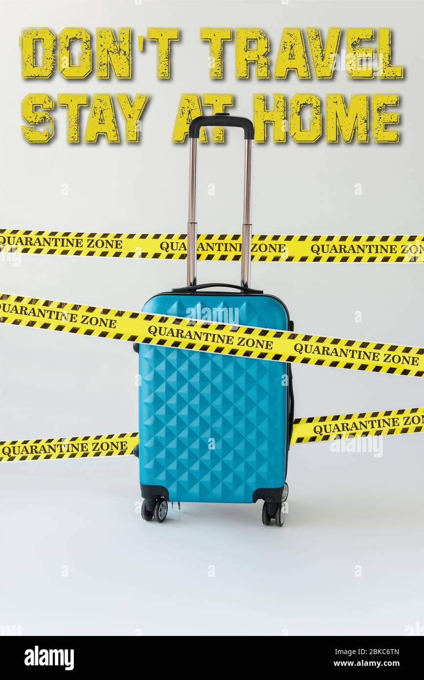 blue suitcase in yellow and black hazard warning safety tape on white ... blue suitcase in yellow and black hazard warning safety tape on white ...