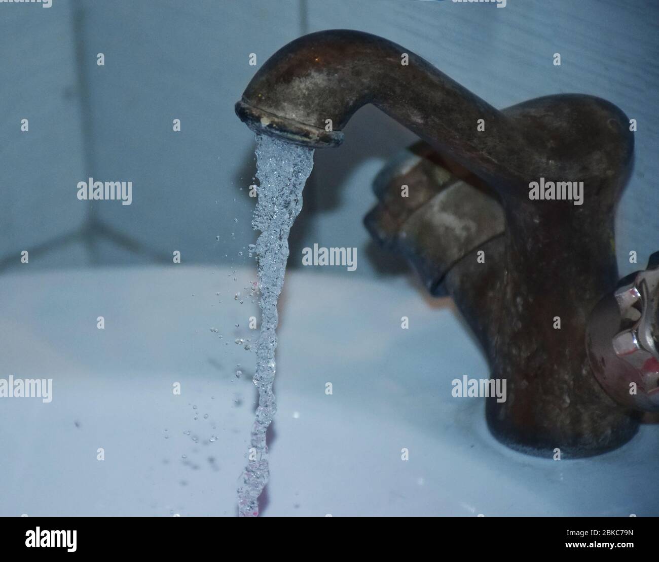 Water Wastage from tap or water flowing freely from tap Stock Photo - Alamy