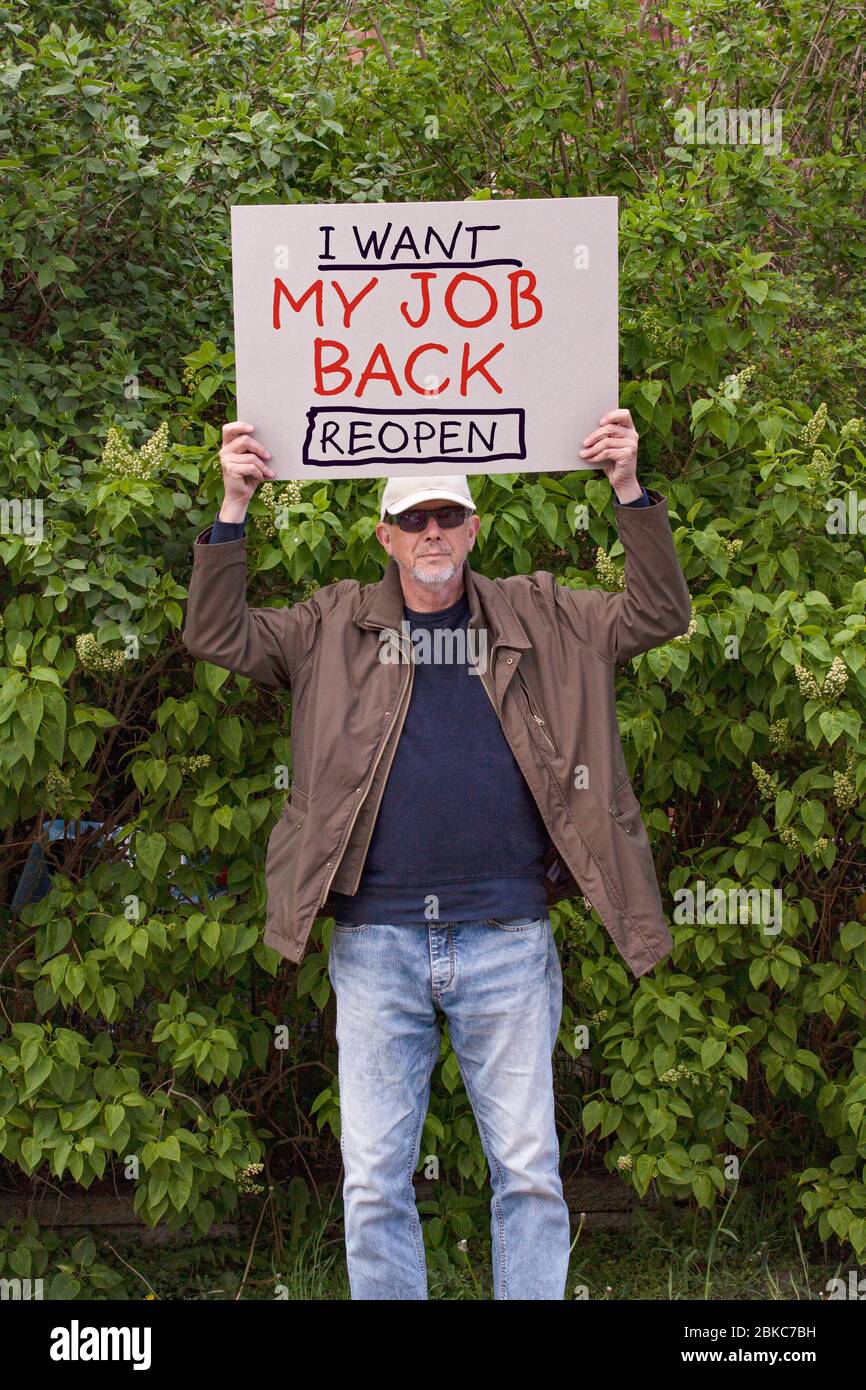Protester with cap and sunglasses demonstrate against stay-at-home ...