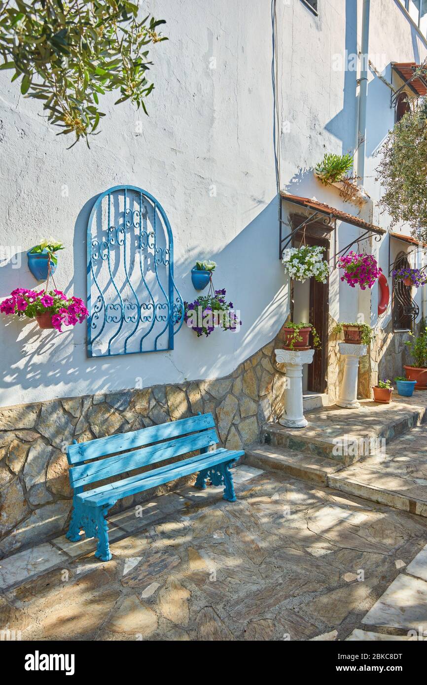 Classic view of a Greek blue window on a white wall with coffee table ...