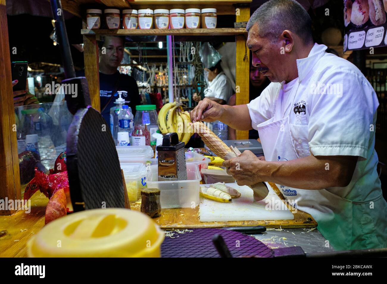 Man cooking Marquesitas. Marquesitas are a typical waffle-like dessert ...