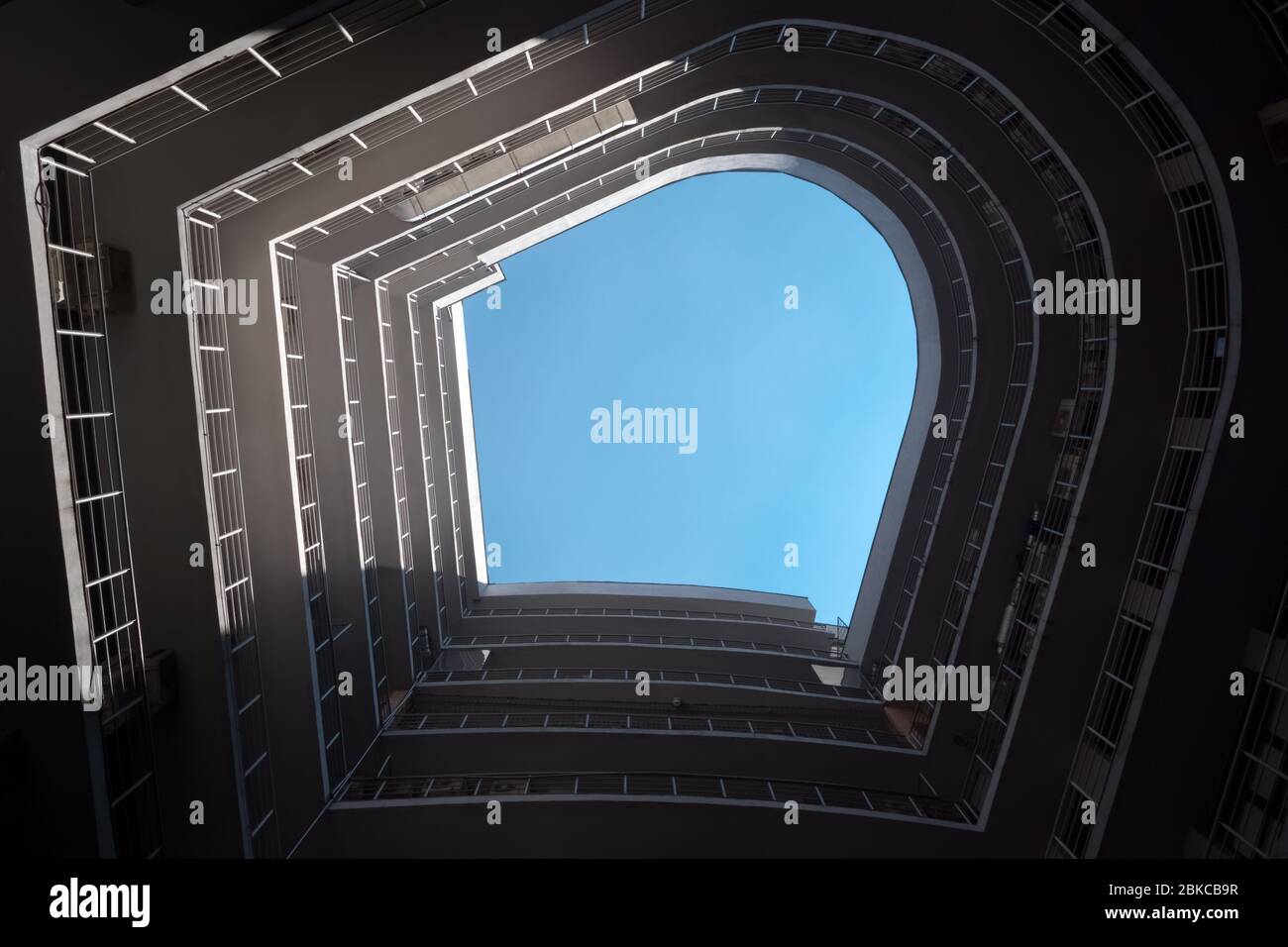 A bottom perspective of rounded shaped building. Real estate. Modern ...