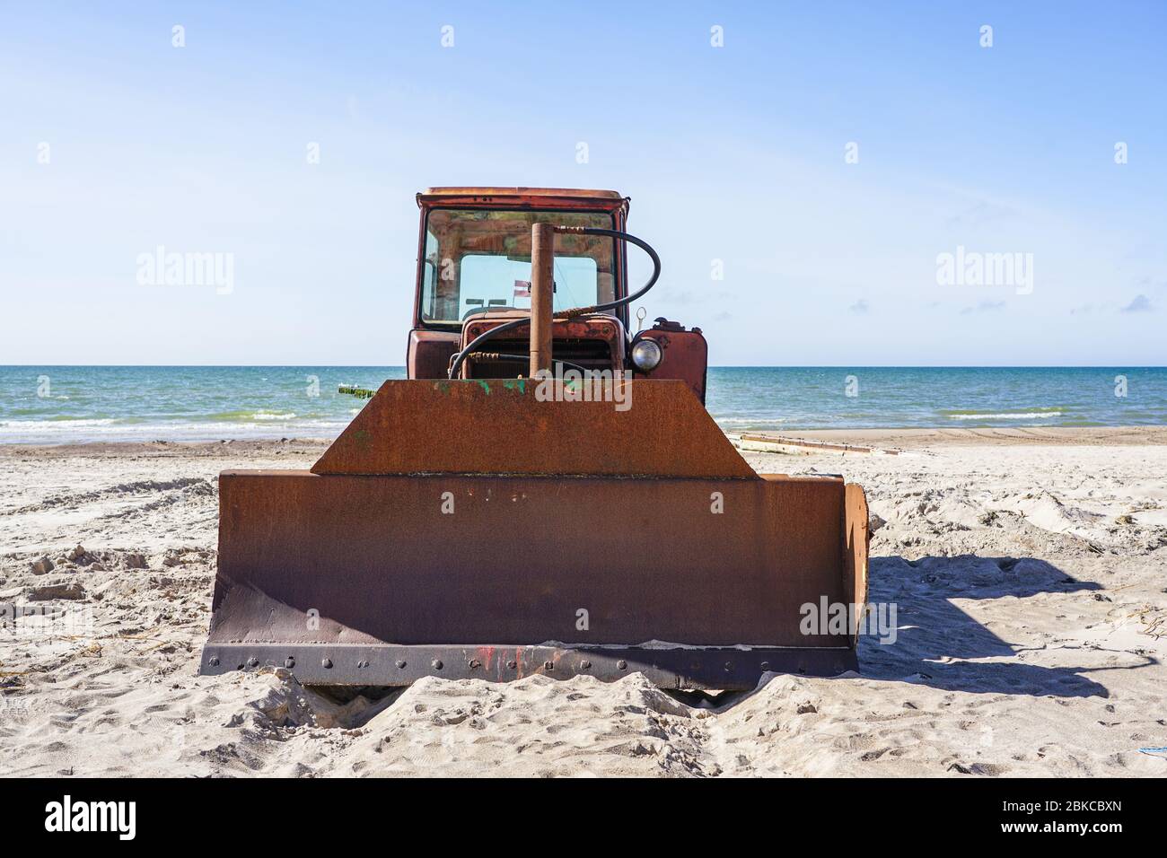 heavy bulldozer as boat puller on the sand by the sea, front view Stock ...