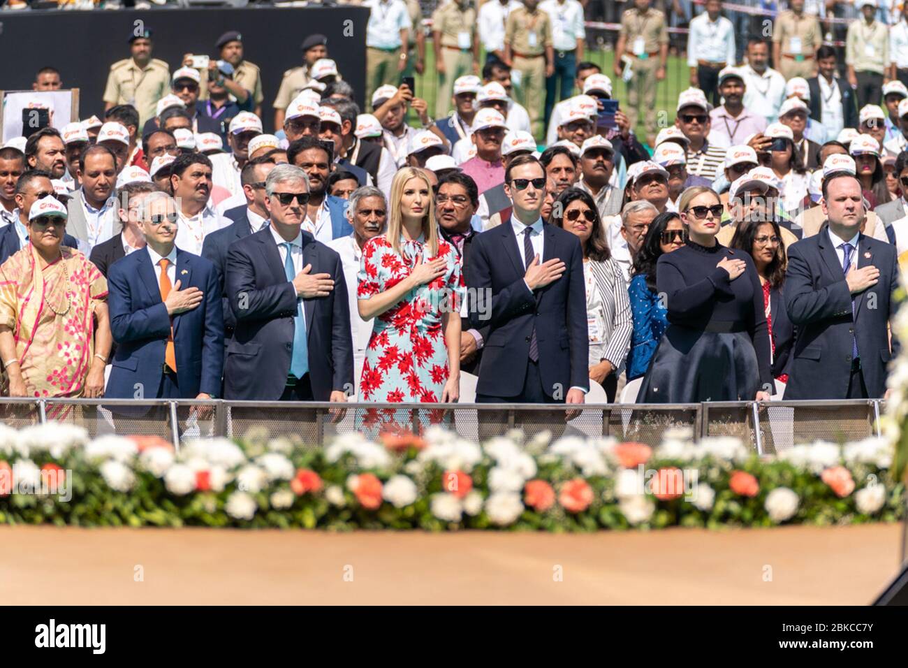 Members of the U.S. delegation stand for the National Anthem at the ...